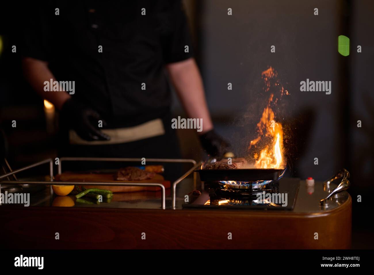 Close-up shot, a professional chef expertly prepares a delicious steak ...