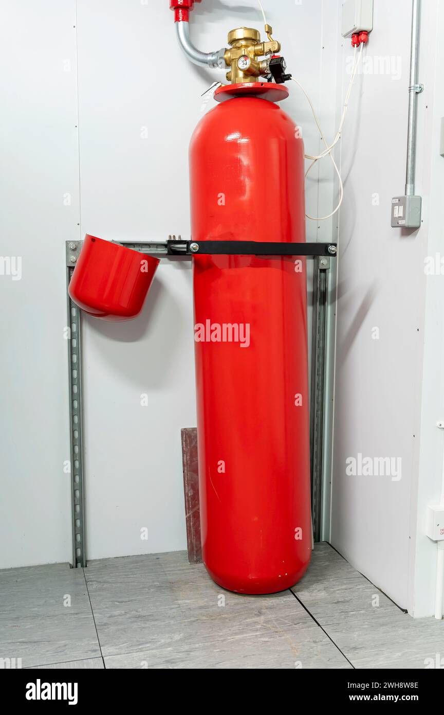 red fire suppression system cylinder, which contains heptafluoropropane ...