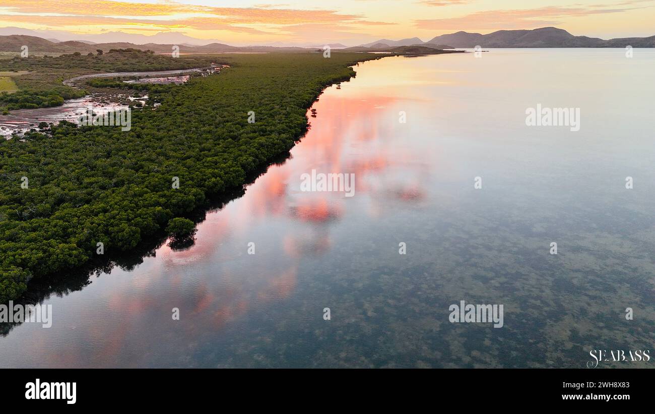 A meandering river winds through a lush green plain framed by majestic ...