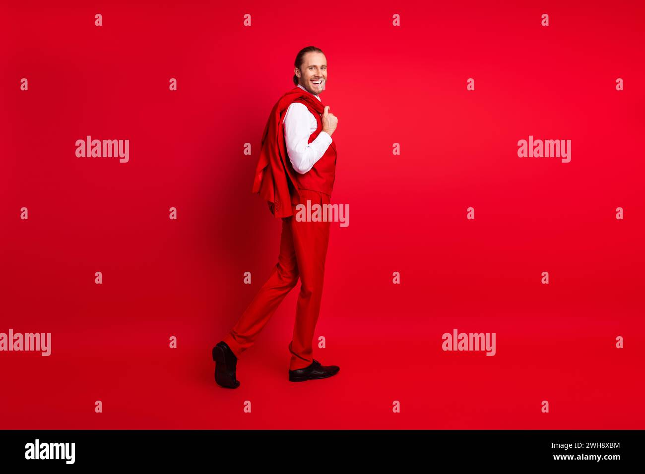 Full body photo of attractive young man walk hold jacket on shoulder ...