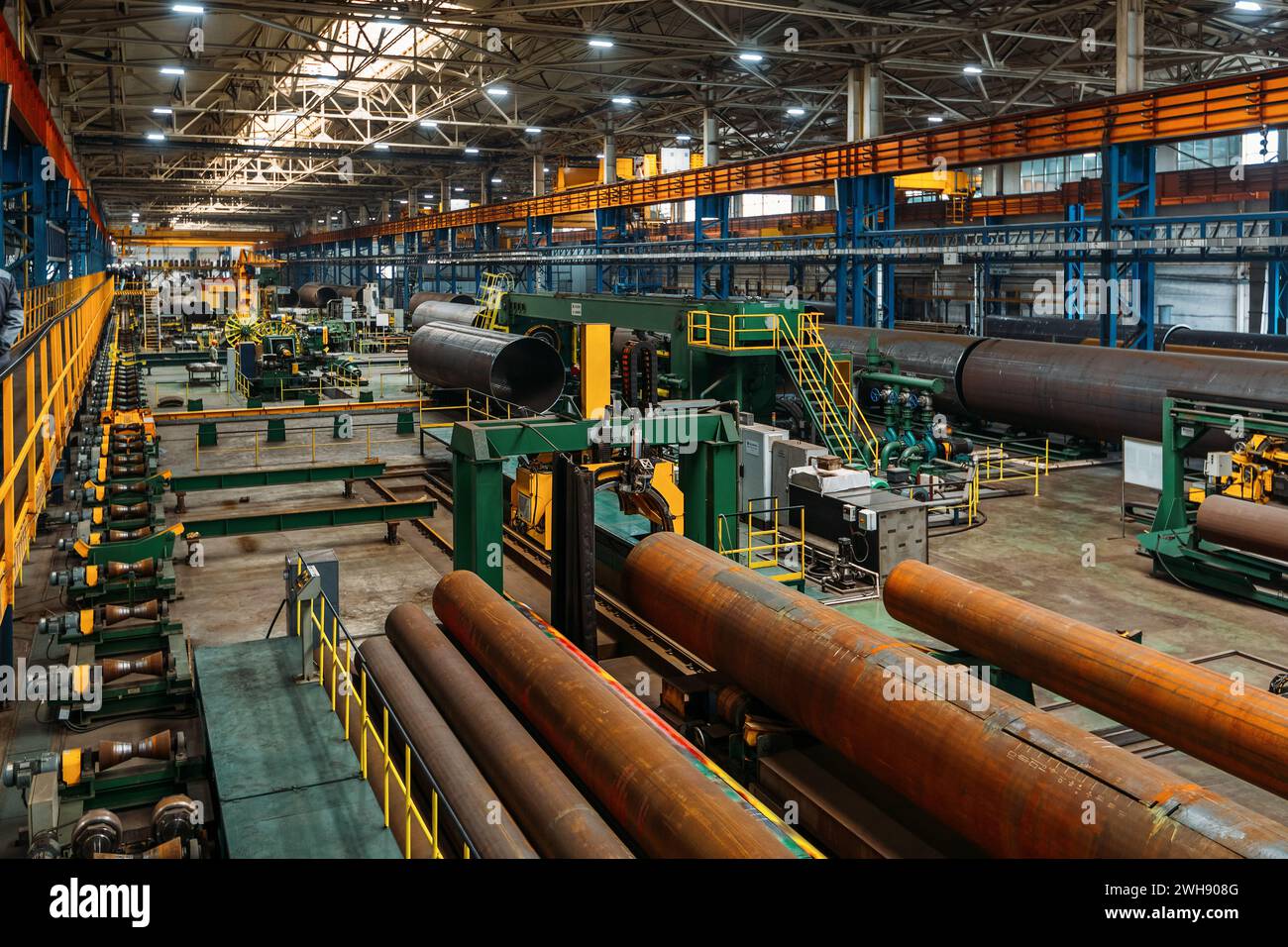 Modern seam pipe factory production line Stock Photo - Alamy