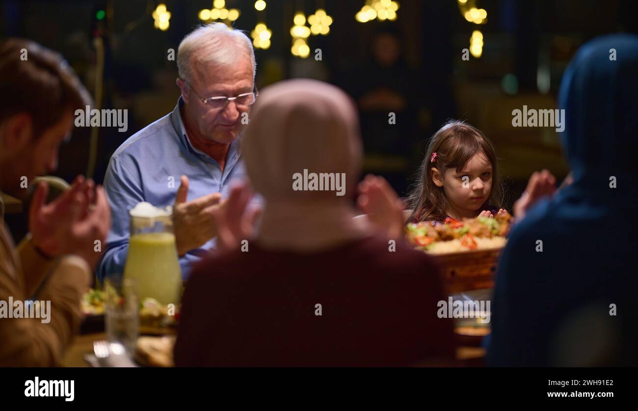 In a modern restaurant setting, a European Islamic family comes ...