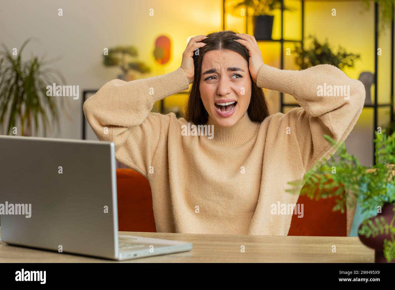 Woman gestures surprise laptop hi-res stock photography and images - Alamy