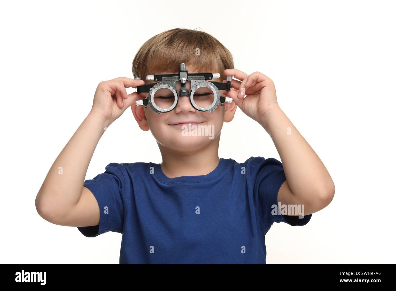 Vision testing. Little boy with trial frame on white background Stock ...