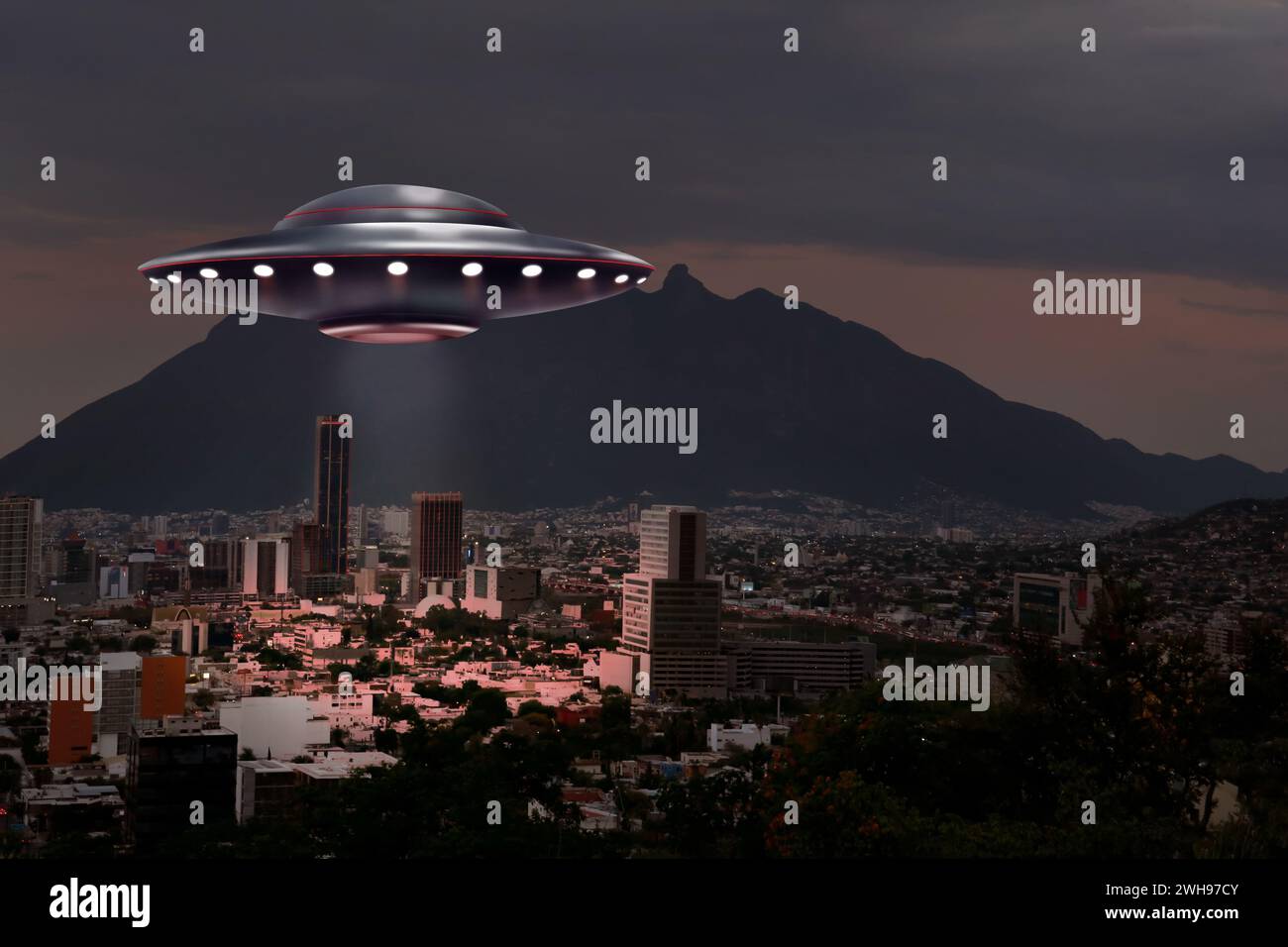 Alien spaceship emitting light over buildings in city. UFO ...