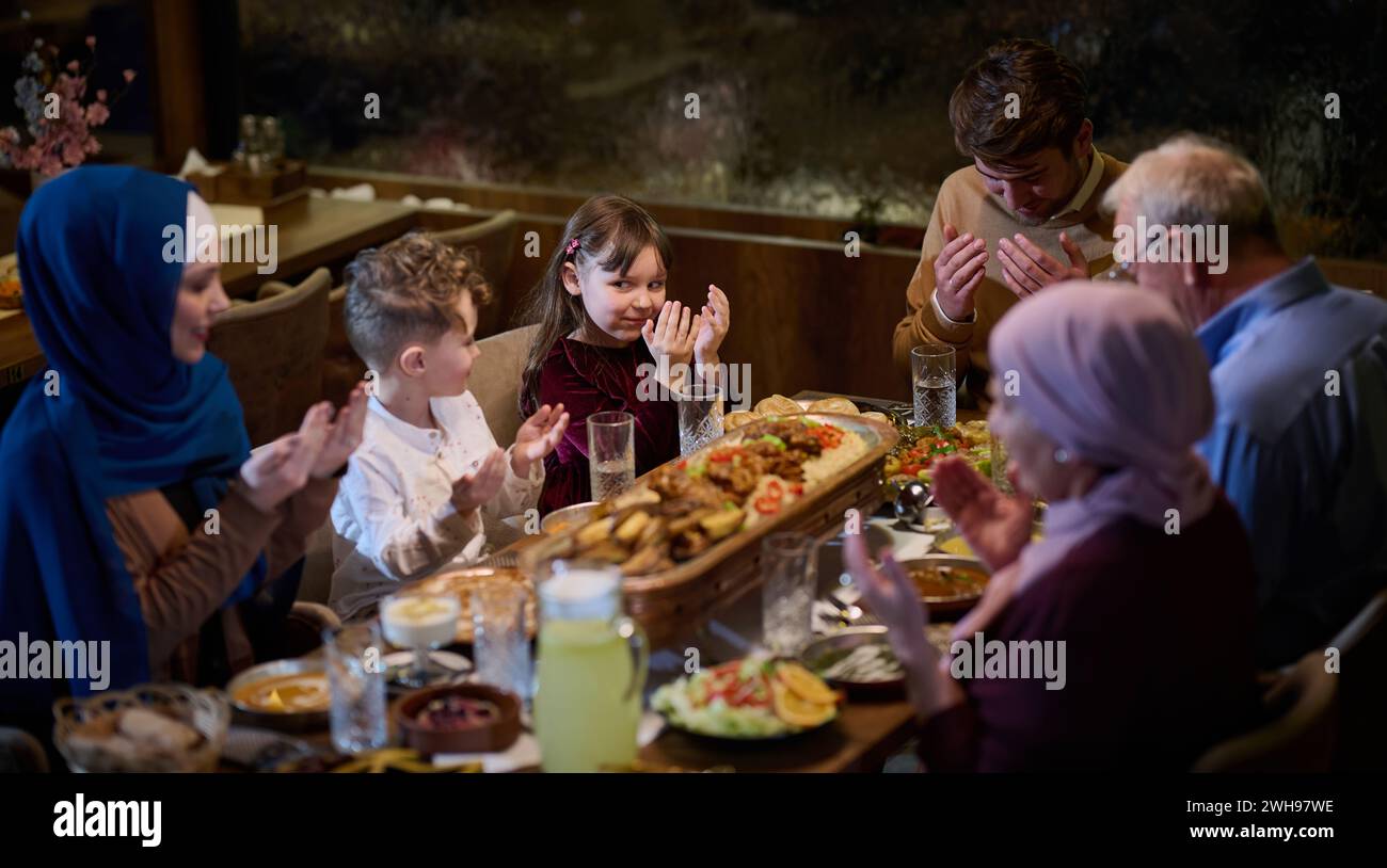 In a modern restaurant setting, a European Islamic family comes ...