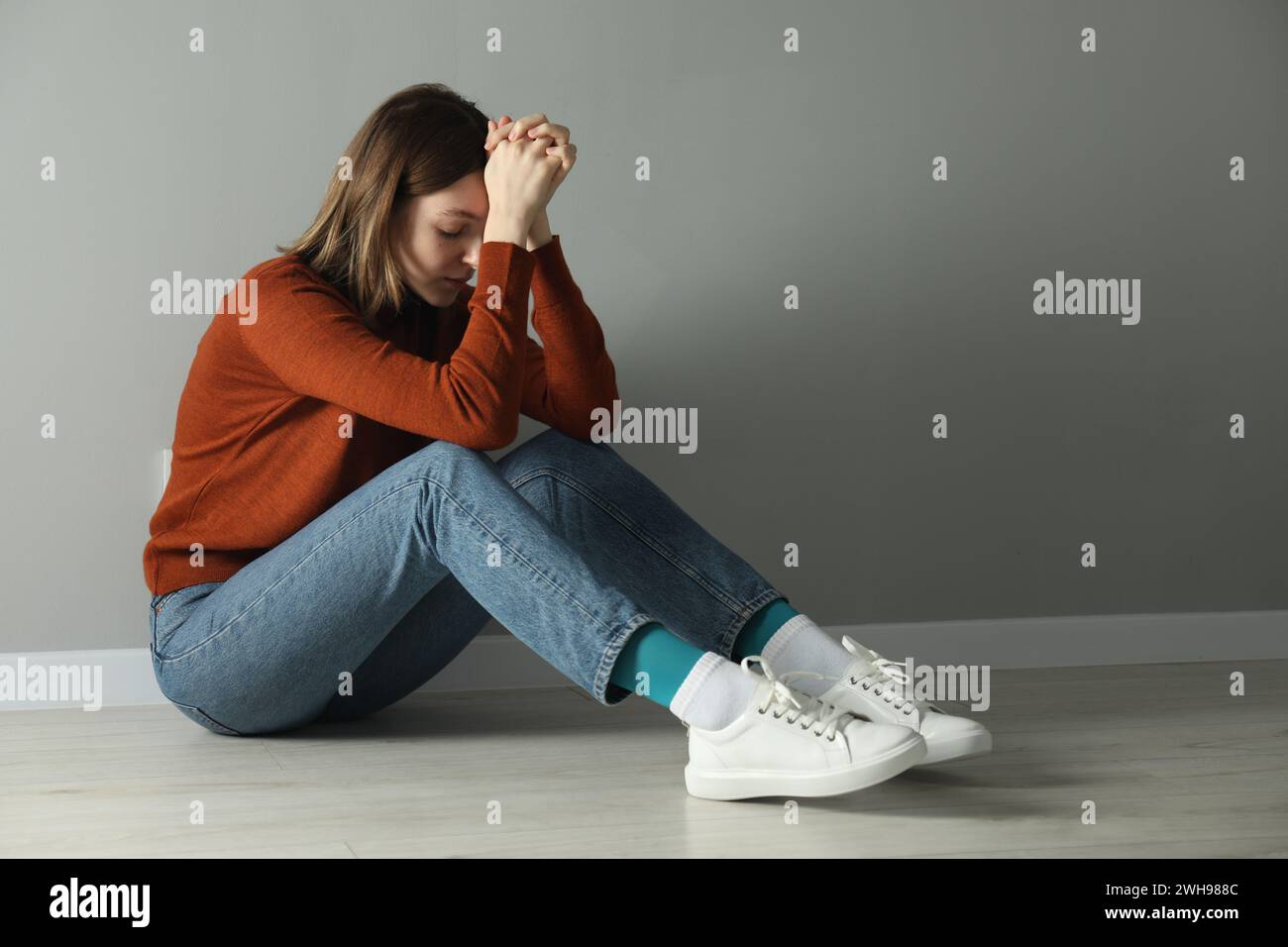 Young sad woman sitting on floor hi-res stock photography and images ...