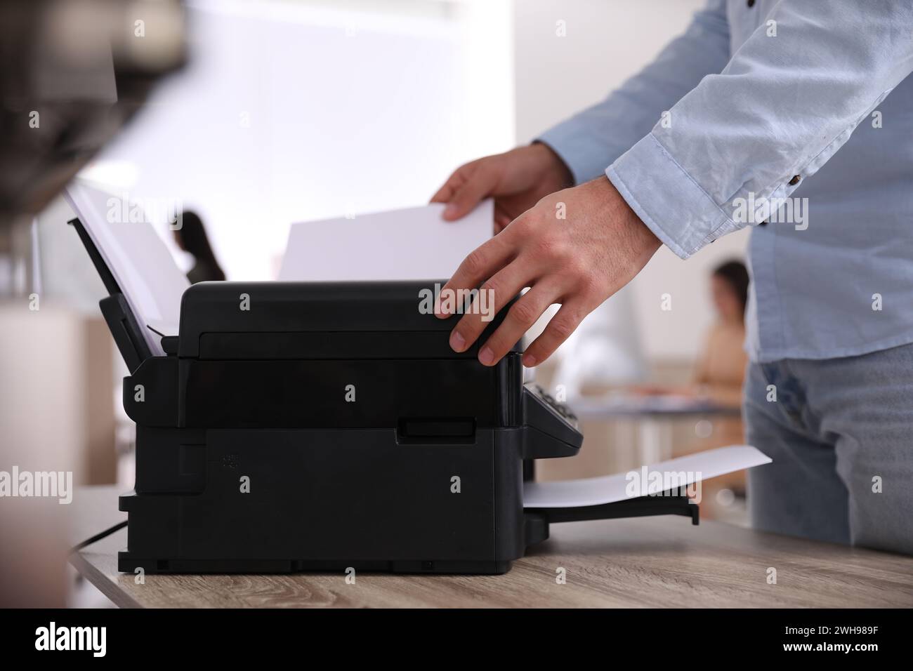 Employee using modern printer in office, closeup Stock Photo - Alamy