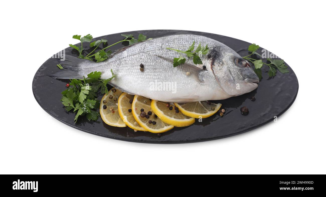 Raw dorado fish, parsley, lemon slices and peppercorns isolated on ...