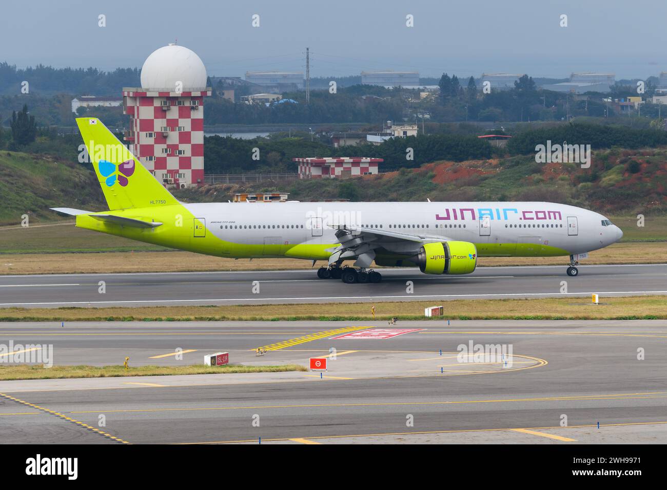 Jin Air Boeing 777 airplane landing. Aircraft B777 of JinAir airline. Plane Boeing 777-200 of ...