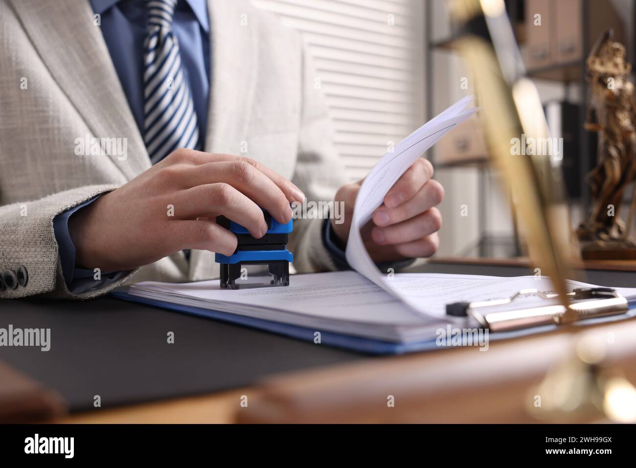 Notary stamping document at table in office, closeup Stock Photo - Alamy