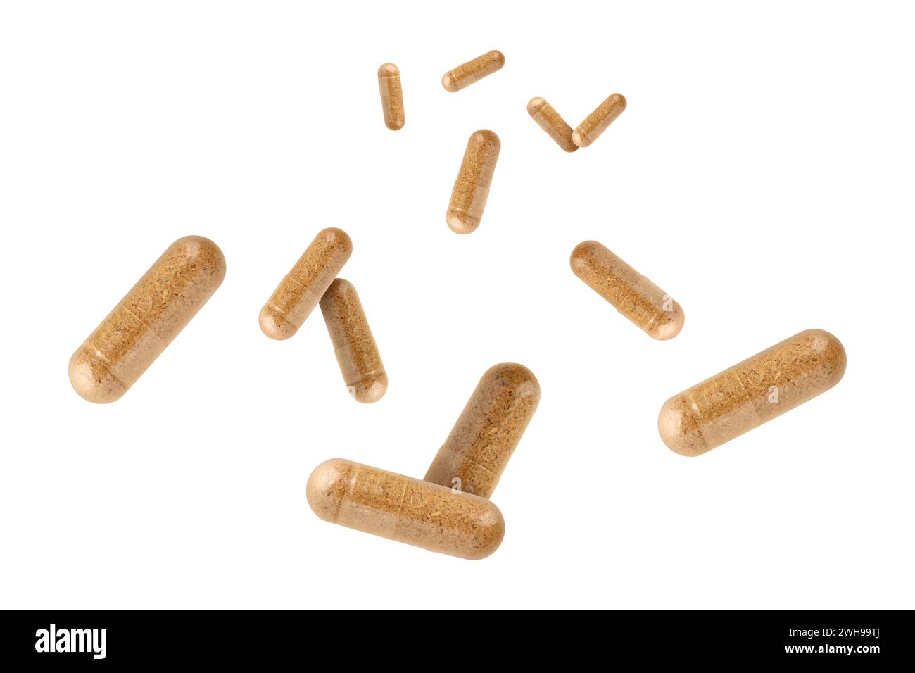 Vitamin. Many capsules falling on white background Stock Photo - Alamy