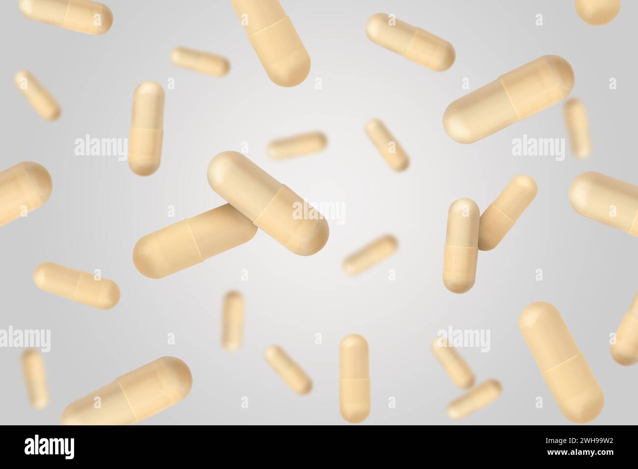 Vitamin. Capsules falling on light grey background Stock Photo - Alamy