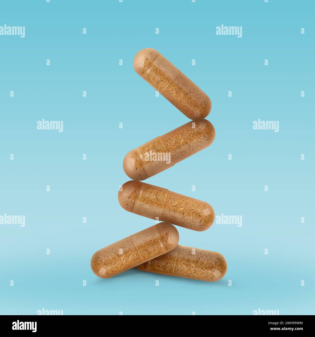 Vitamin. Capsules falling on light blue gradient background Stock Photo ...