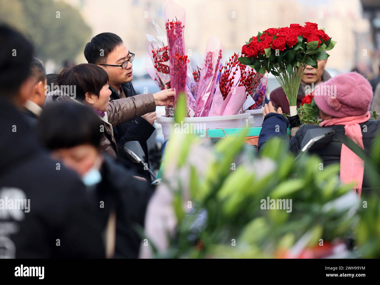 HEFEI, CHINA - FEBRUARY 8, 2024 - People shop for New Year flowers at ...