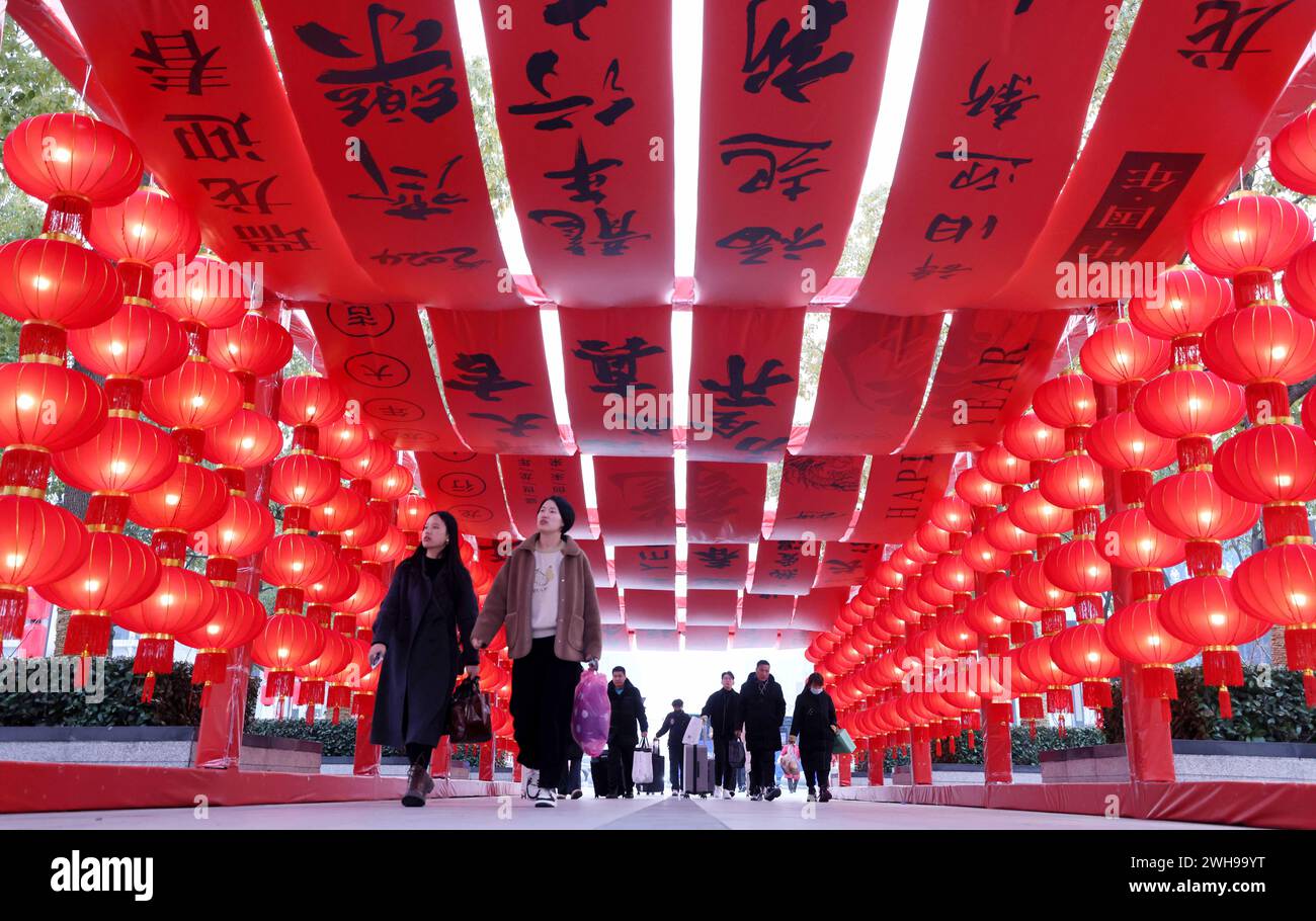 HEFEI, CHINA - FEBRUARY 8, 2024 - Tourists walk through the red lantern ...