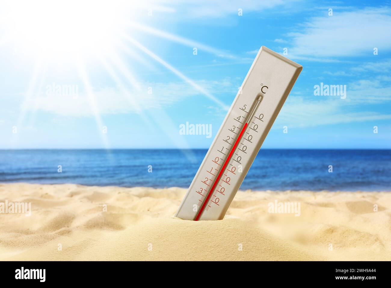 Thermometer on beach showing high temperature during hot summer day ...
