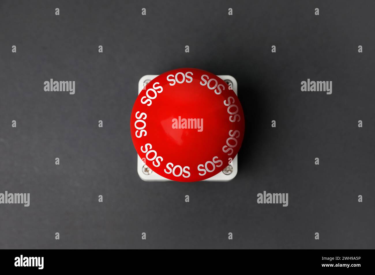 Red SOS button on dark grey background. Space for text Stock Photo - Alamy