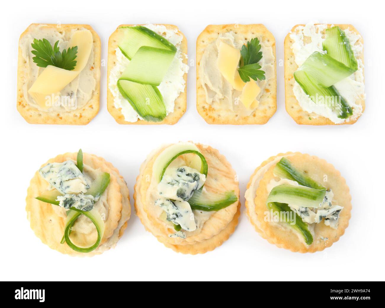 Delicious crackers with different toppings isolated on white, top view ...