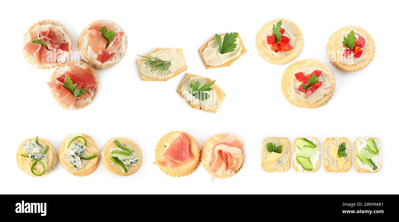 Delicious crackers with different toppings isolated on white, top view ...