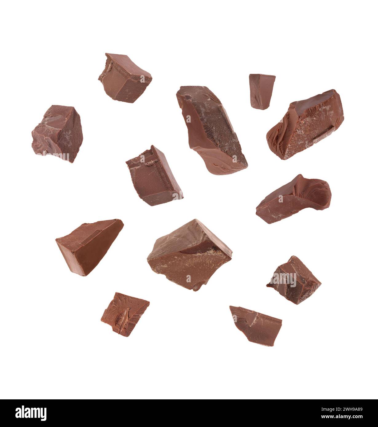 Tasty chocolate chunks falling on white background Stock Photo - Alamy