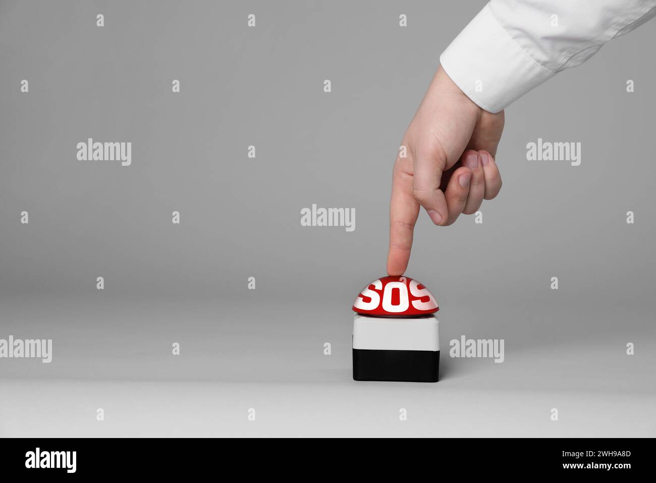 Man pressing red SOS button at white background, closeup Stock Photo ...