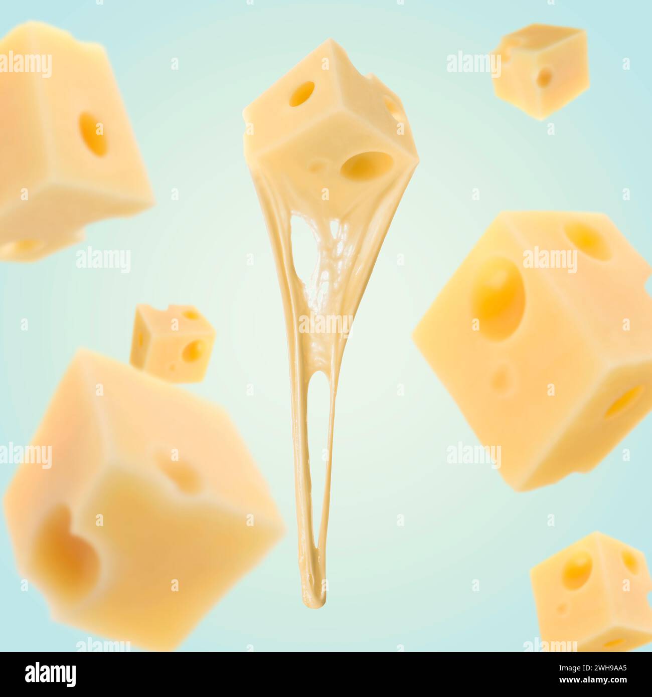 Pieces of cheese falling on light blue background Stock Photo - Alamy