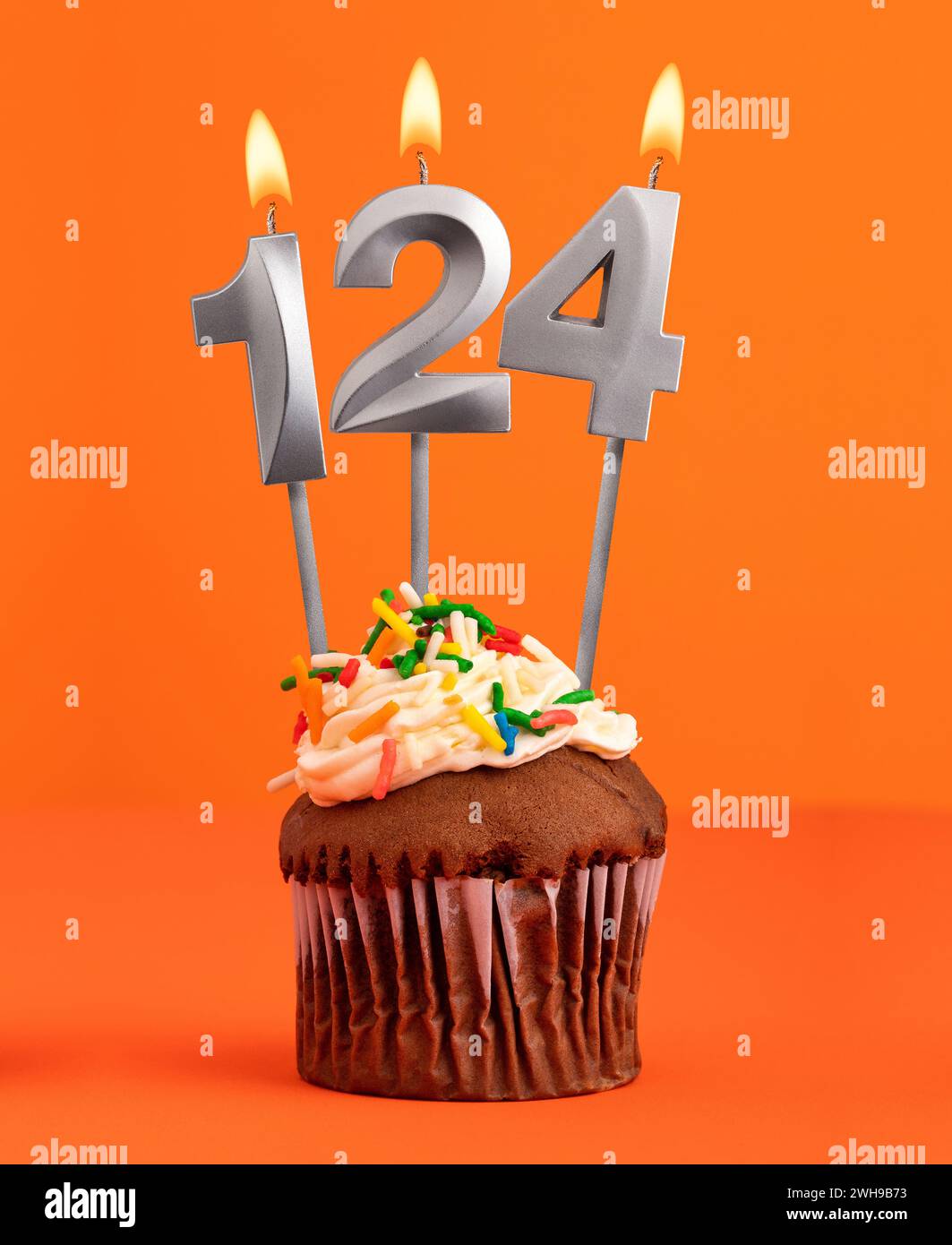 Birthday cupcake with number 124 candle - Orange color background Stock ...
