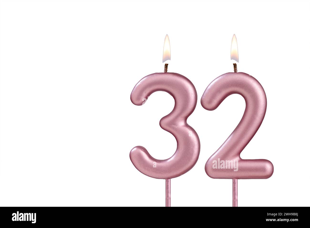 Lit birthday candle - Candle number 32 on white background Stock Photo ...