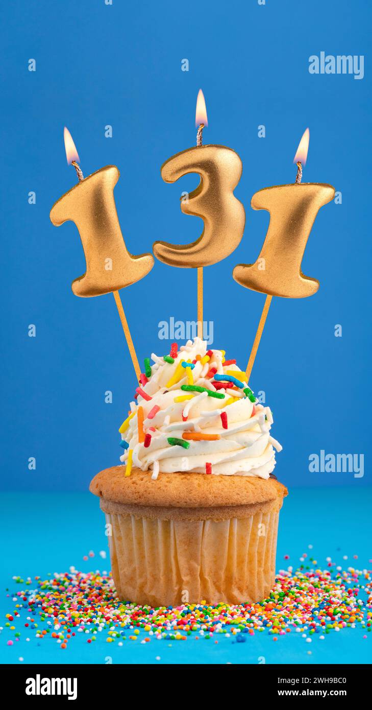 Candle number 131 - Cupcake birthday in blue background Stock Photo - Alamy