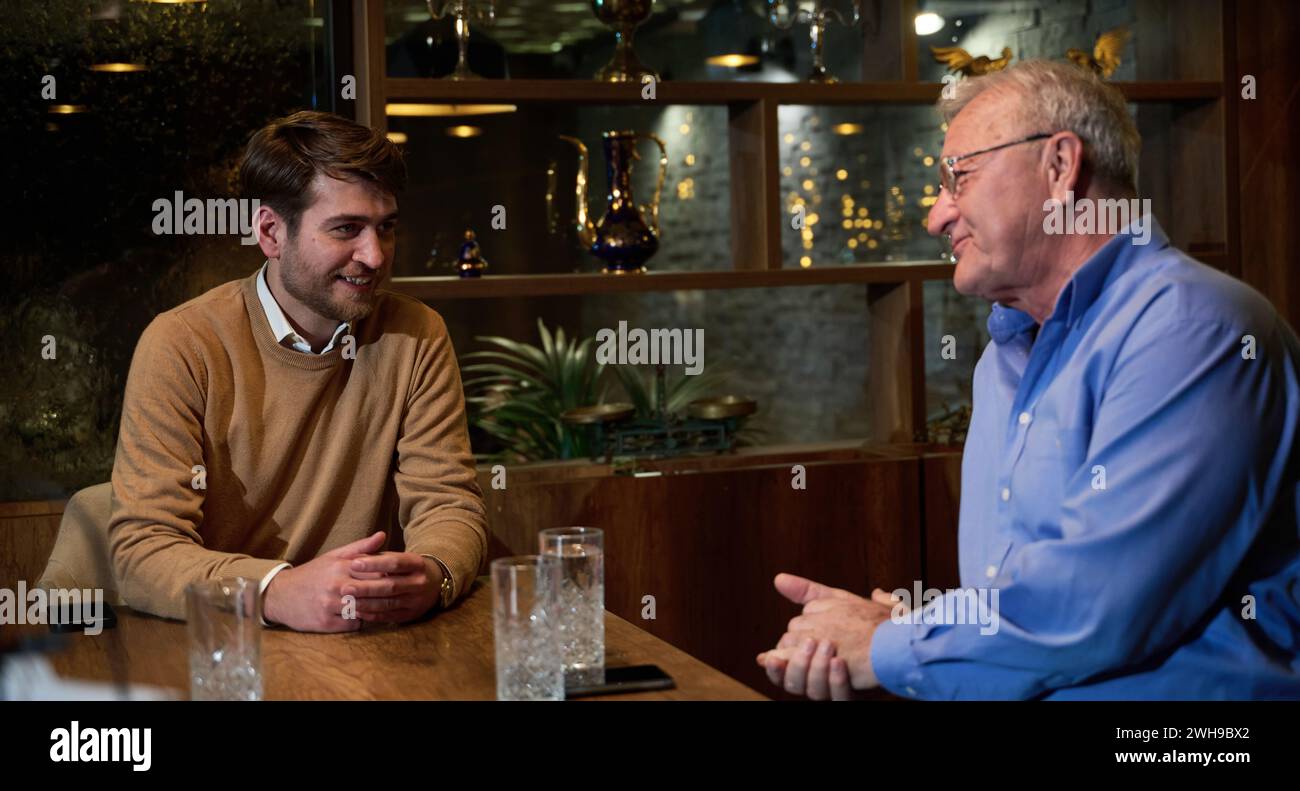 A son and his elderly father engage in heartfelt conversation while ...