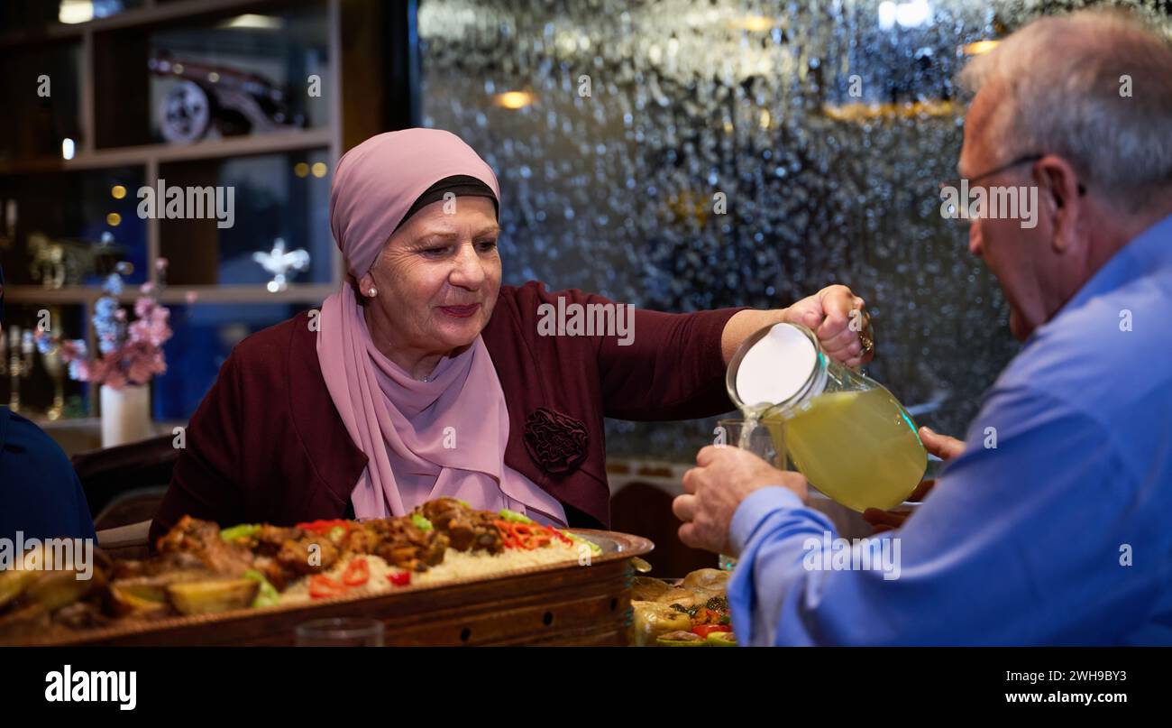 In a modern restaurant setting, an elderly Islamic European couple ...