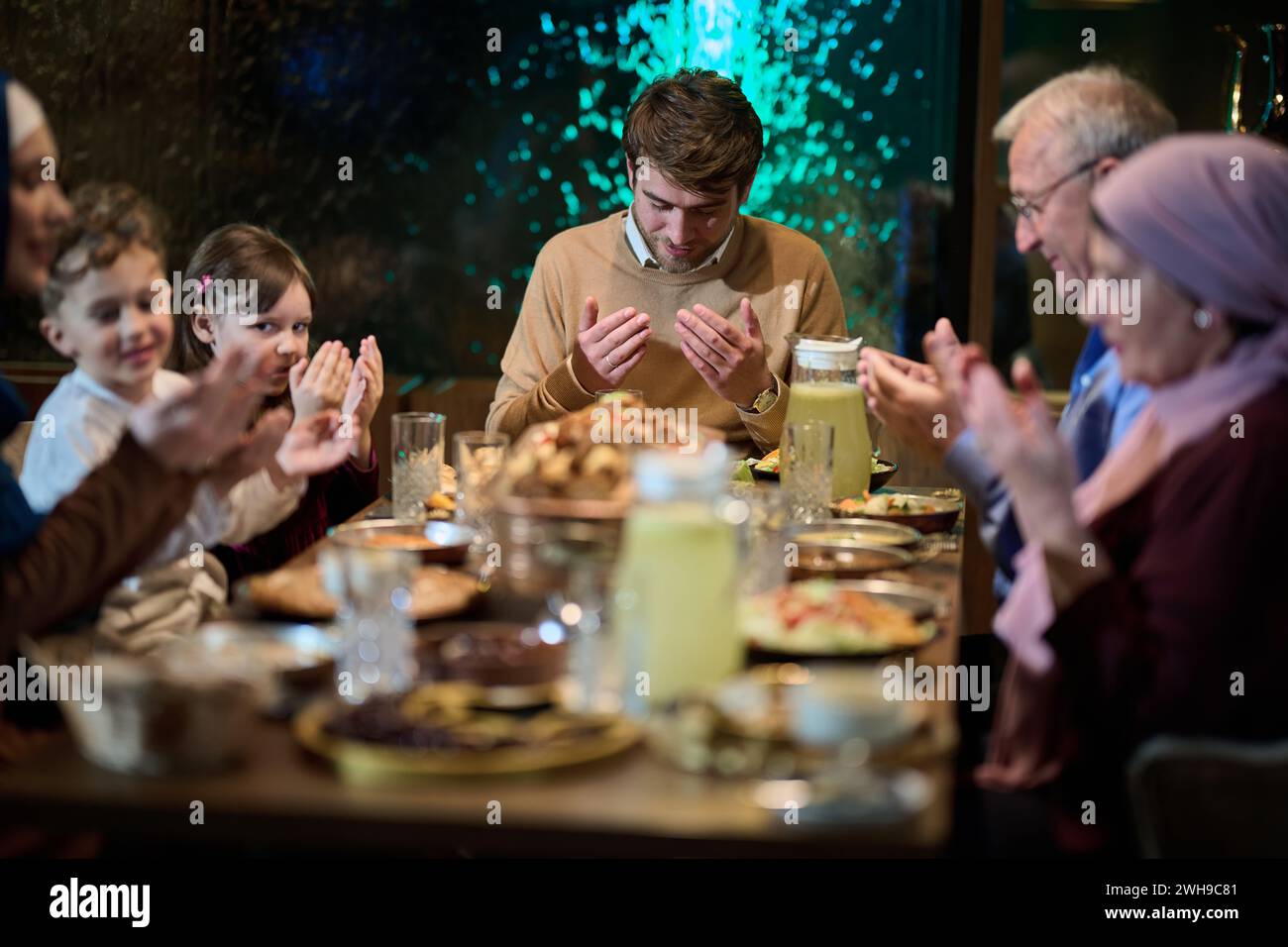 In a modern restaurant setting, a European Islamic family comes ...