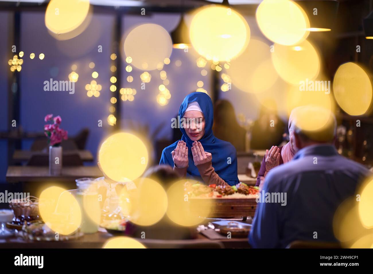 In a modern restaurant setting, a European Islamic family comes ...