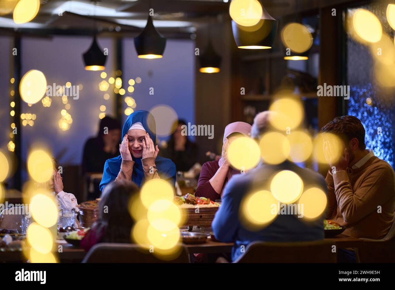 In a modern restaurant setting, a European Islamic family comes ...