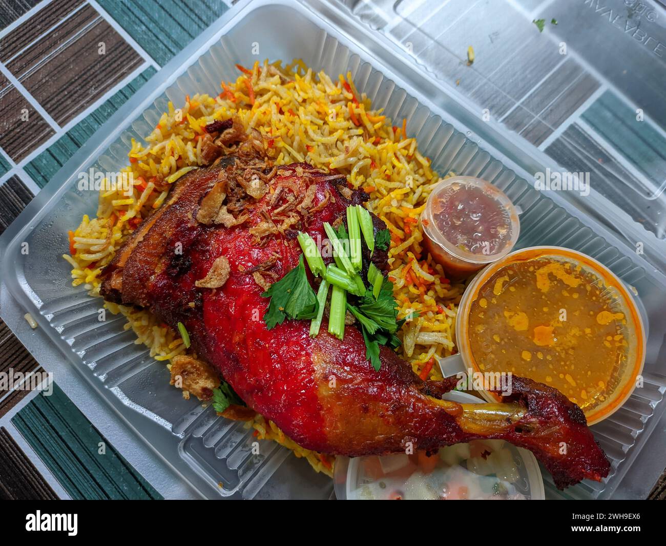 Top view arabic rice with red chicken thighs,colorful rice and curry ...