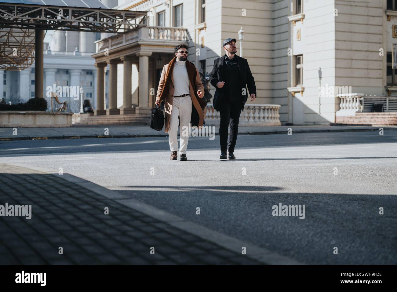 Two stylish men walking confidently outdoors in an urban setting Stock ...