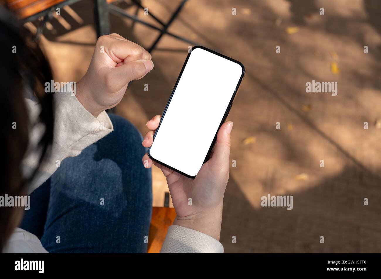 A close-up shot features a woman showing a clenched fist while using ...