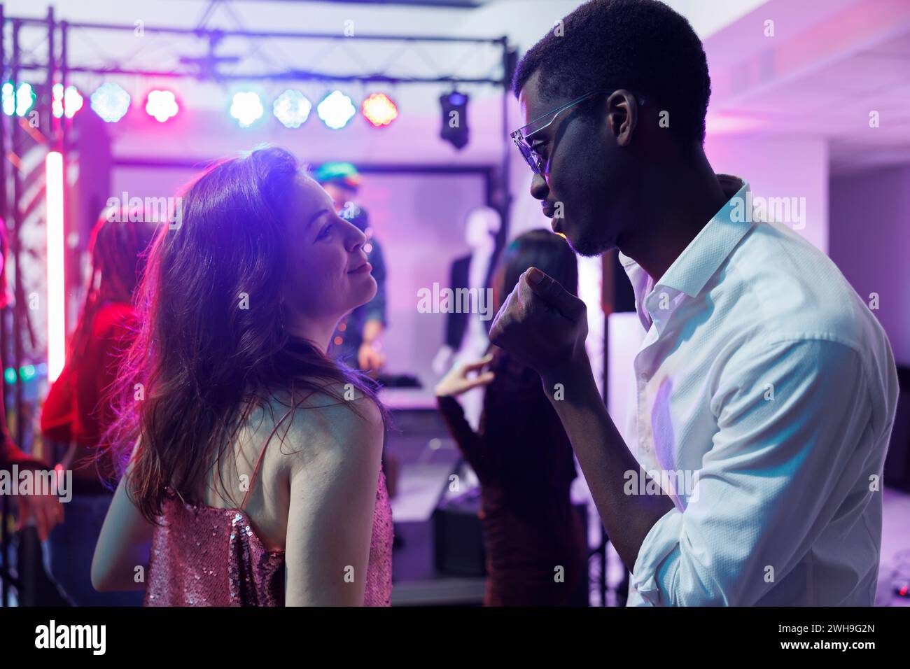 Couple in love dancing and clubbing while attending disco party in ...