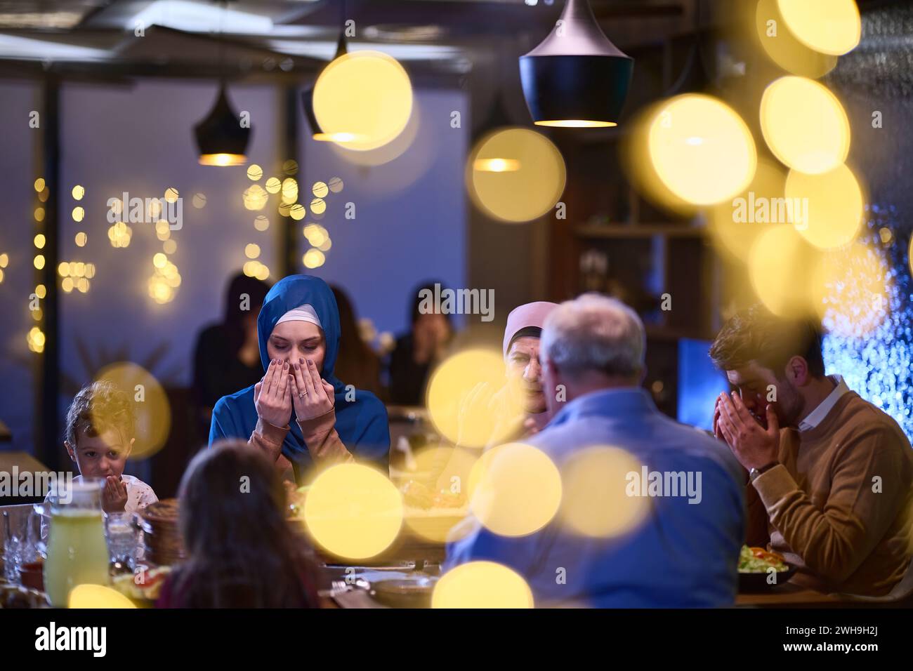 In a modern restaurant setting, a European Islamic family comes ...