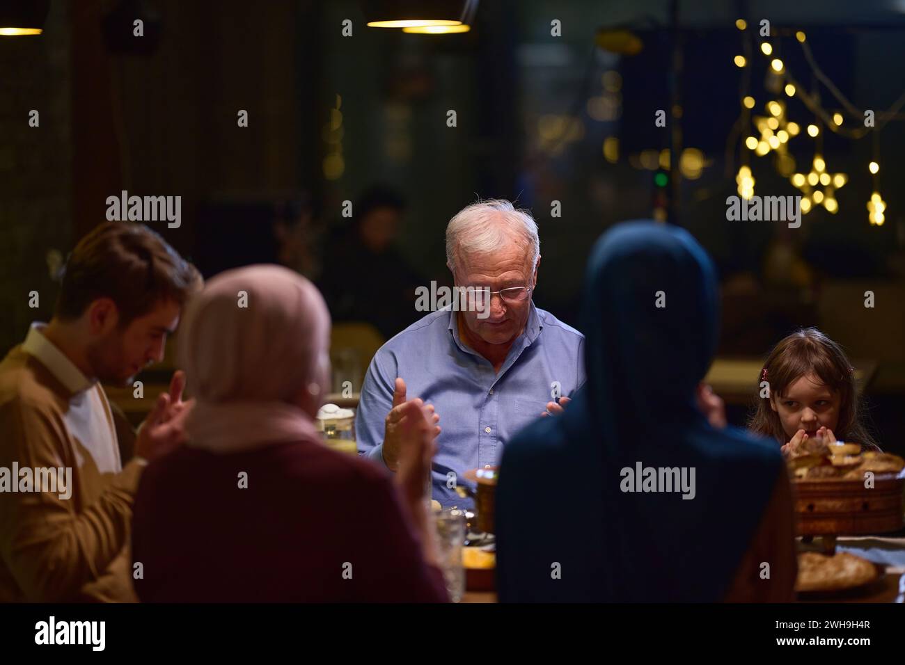 In a modern restaurant setting, a European Islamic family comes ...