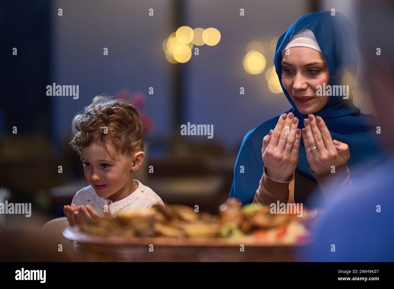 In a modern restaurant setting, a European Islamic family comes ...