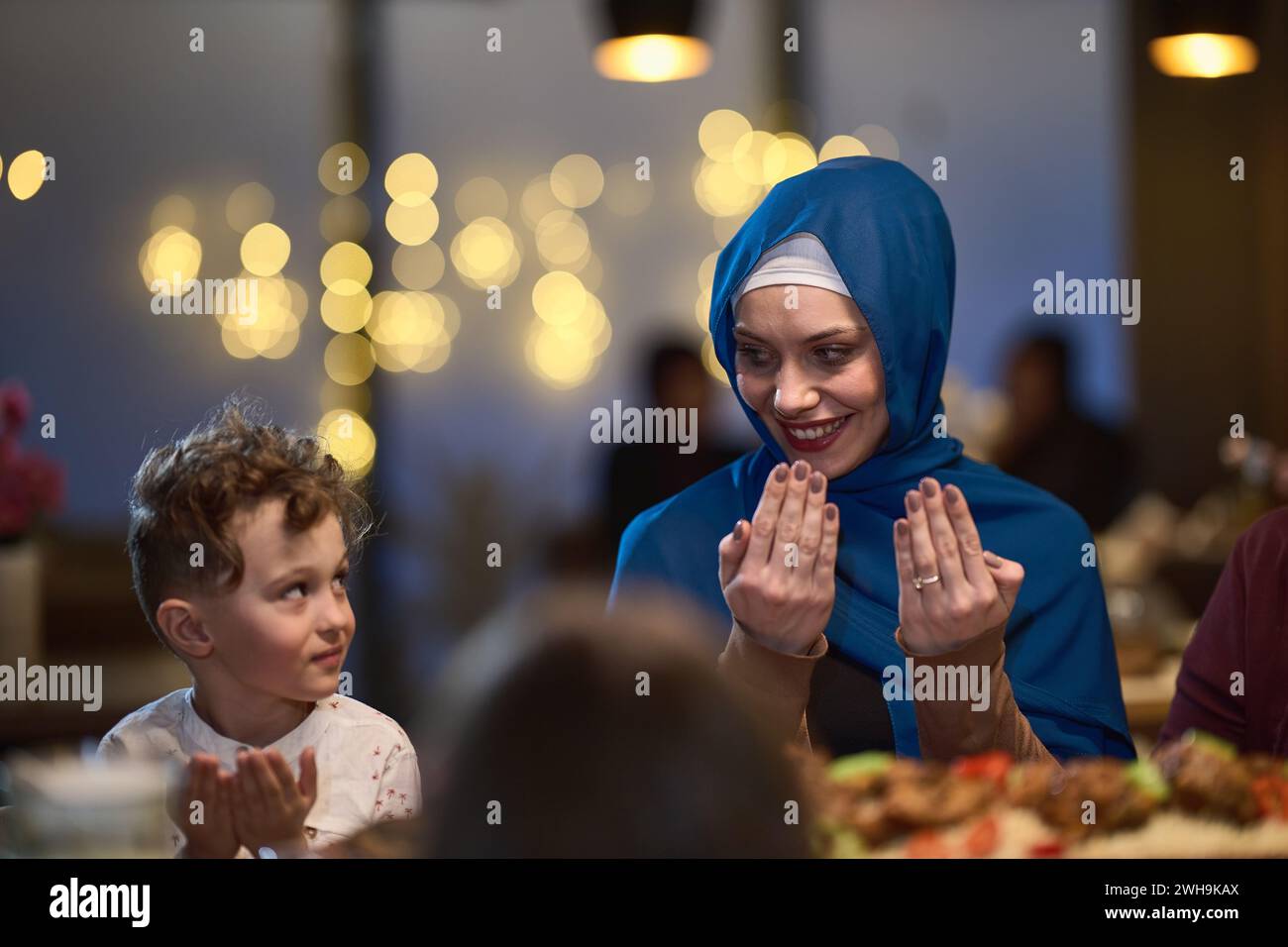 In a modern restaurant setting, a European Islamic family comes ...