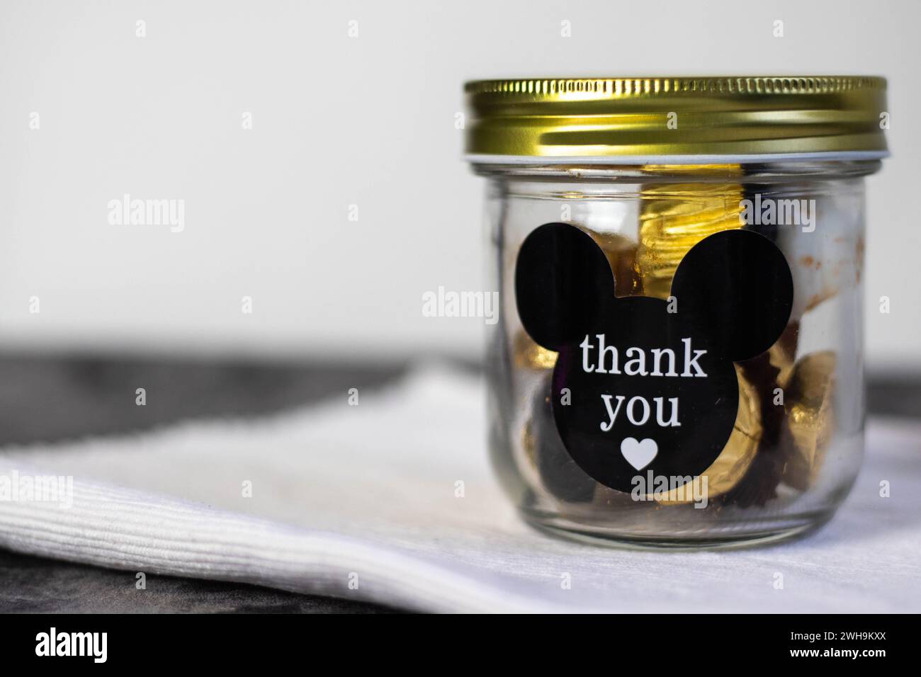 Thank you black mouse sticker with white writing and heart on a clear ...