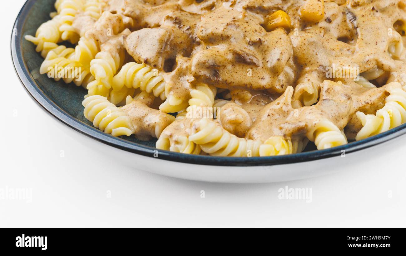 pasta with chicken and cream sauce on a plate isolated on white ...