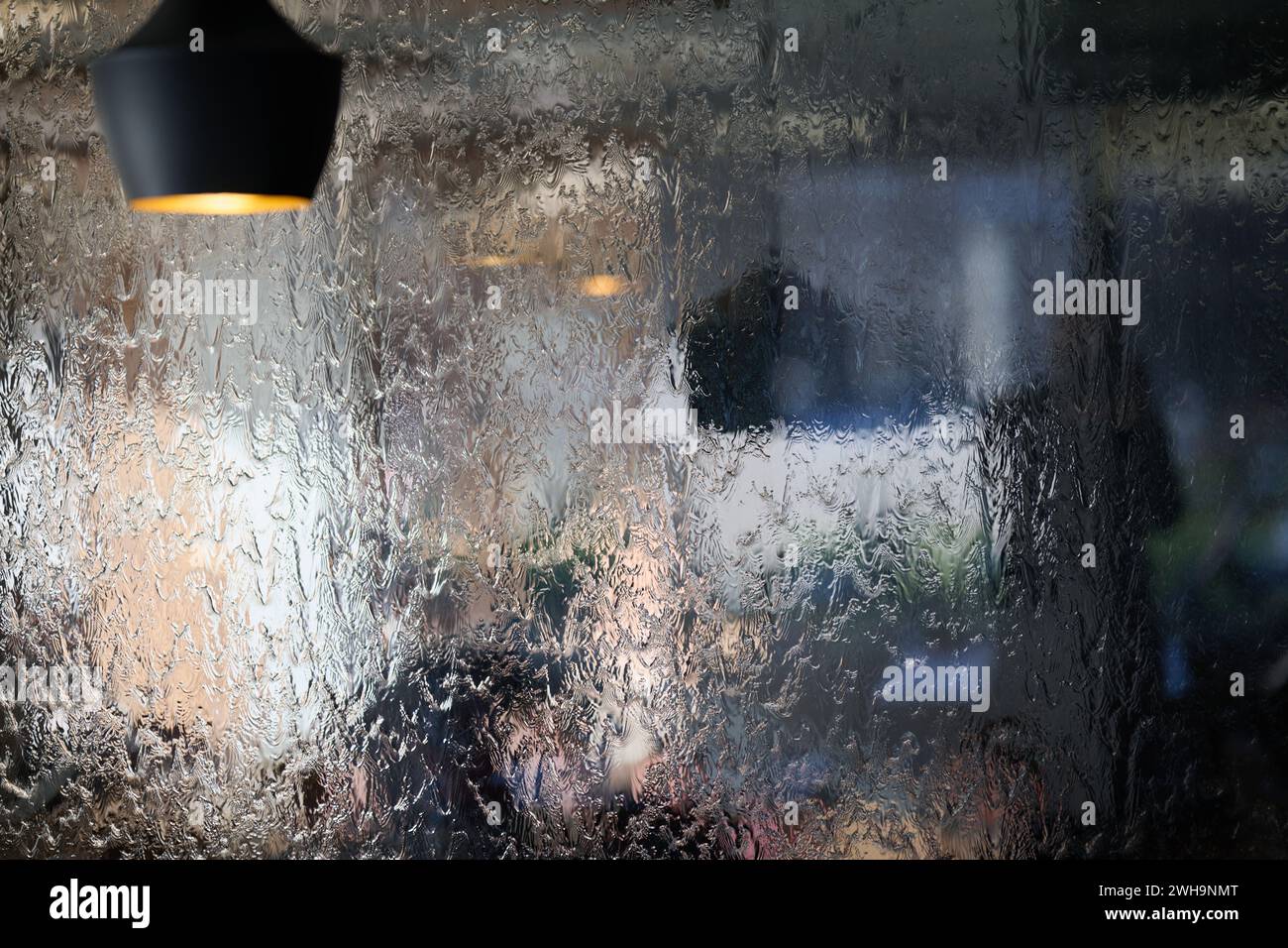 In a close-up capture, the texture of glass through which water flows ...