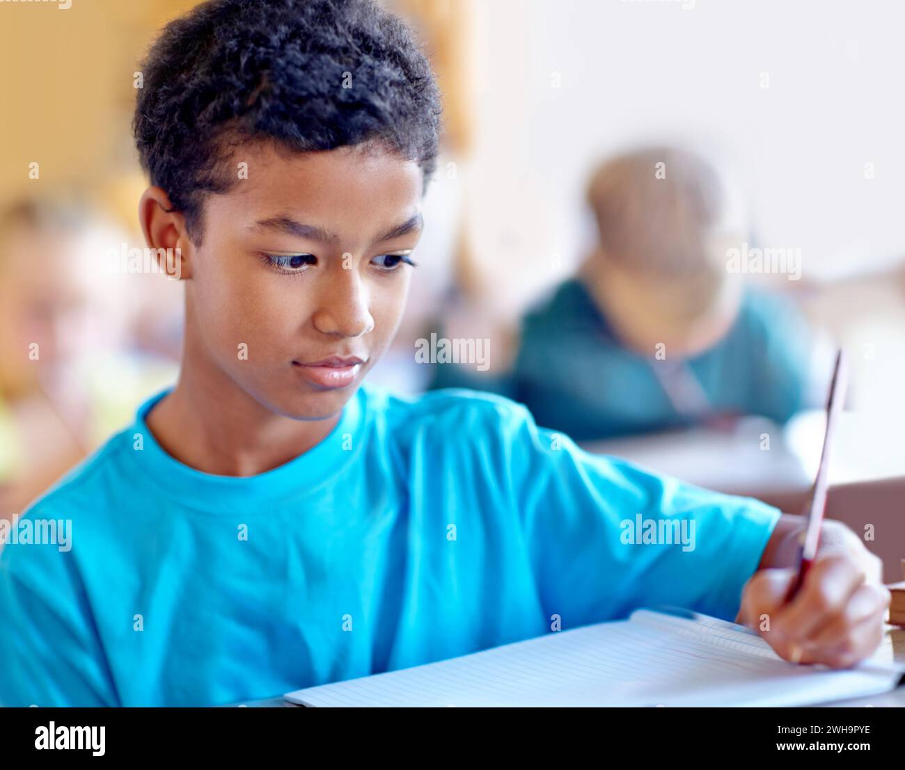 Student, boy and writing notes for knowledge in classroom, book and ...