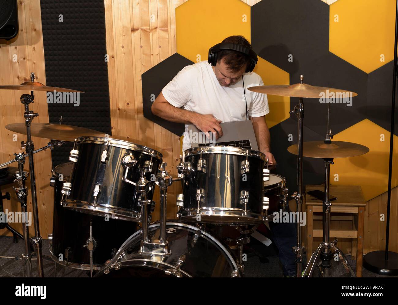 White Caucasian man connects drums, musical instrument and app on ...