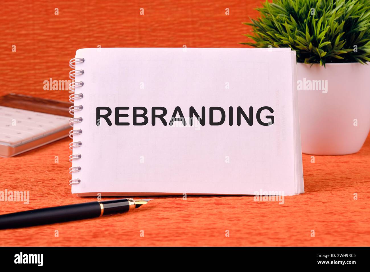 rebranding word written on a blank sheet of notepad, there is a ...