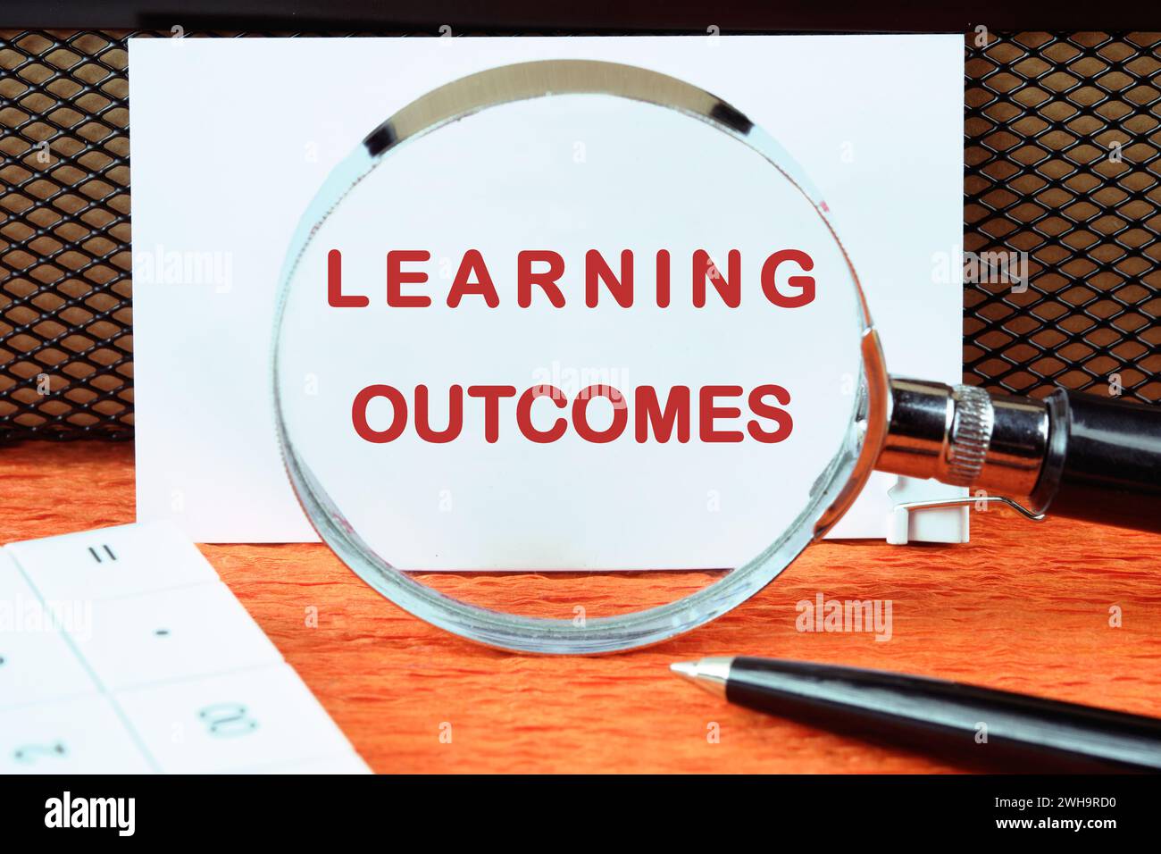 Learning Outcome write on a white card through a magnifying glass Stock ...